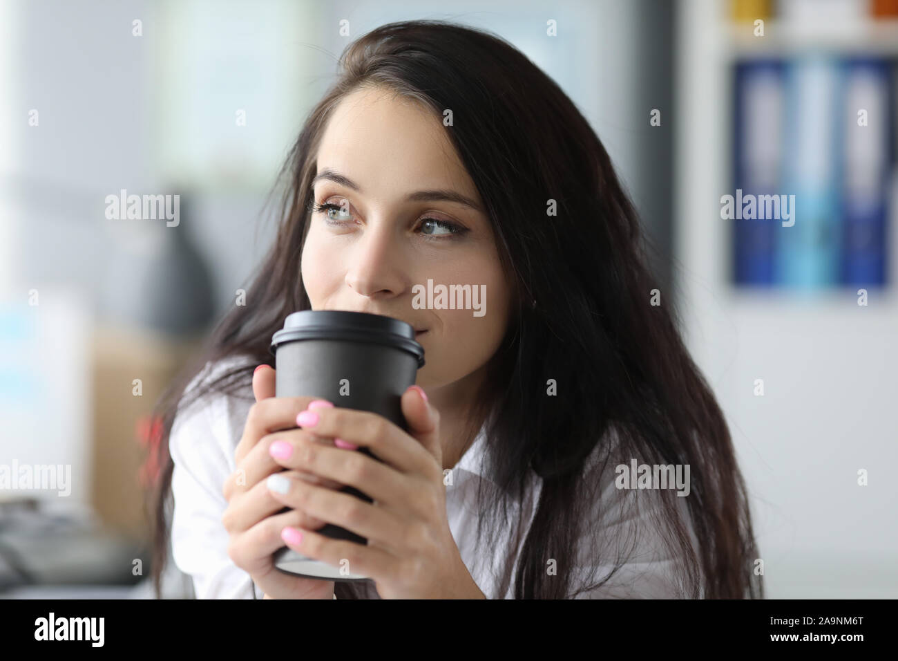 Lady drinking tea in office hi-res stock photography and images - Alamy