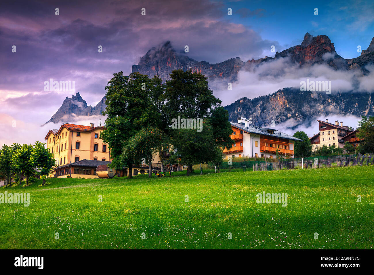 Beautiful mountain resort with houses and gardens. Alpine village with ...