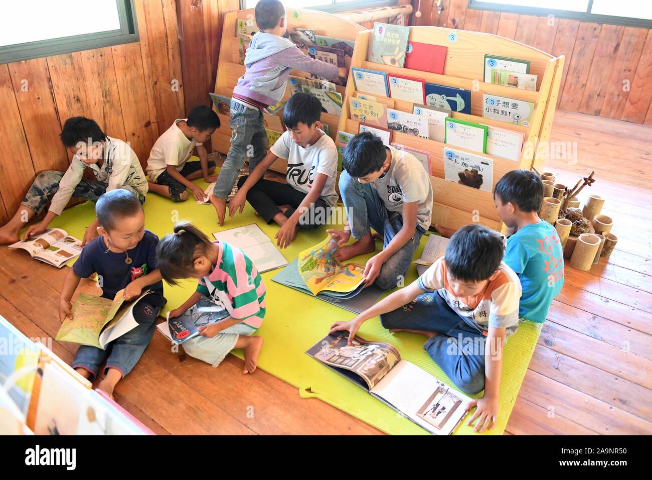 Mengla, China's Yunnan Province. 16th Nov, 2019. Children read books at ...