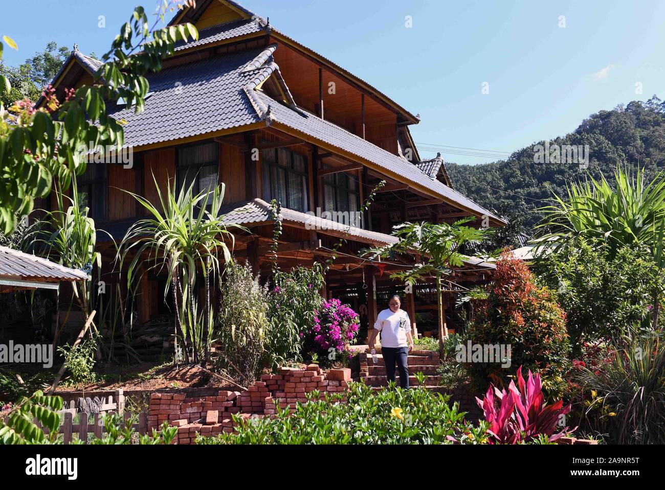Mengla, China's Yunnan Province. 16th Nov, 2019. A woman walks out of ...