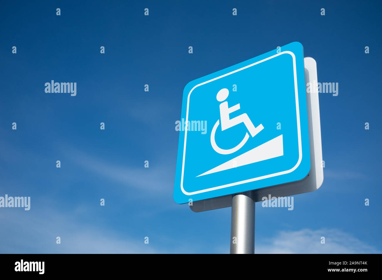 Disabled parking signage on the pole in blue and white color with ...