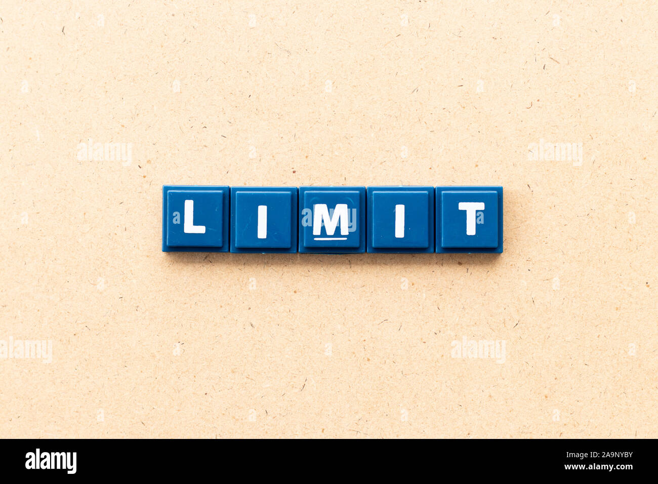 Tile letter in word limit on wood background Stock Photo - Alamy