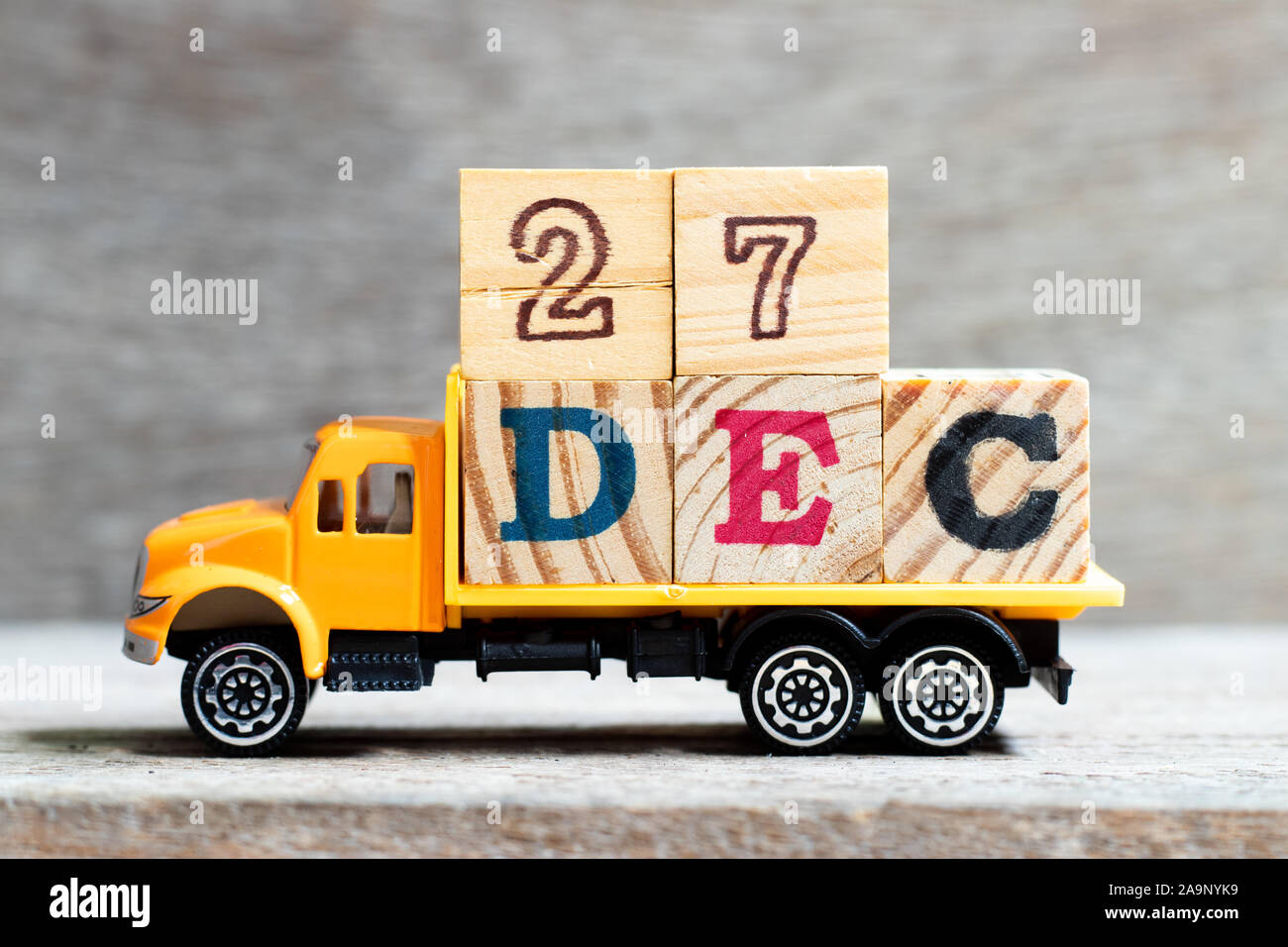 Truck hold letter block in word 27dec on wood background (Concept for ...