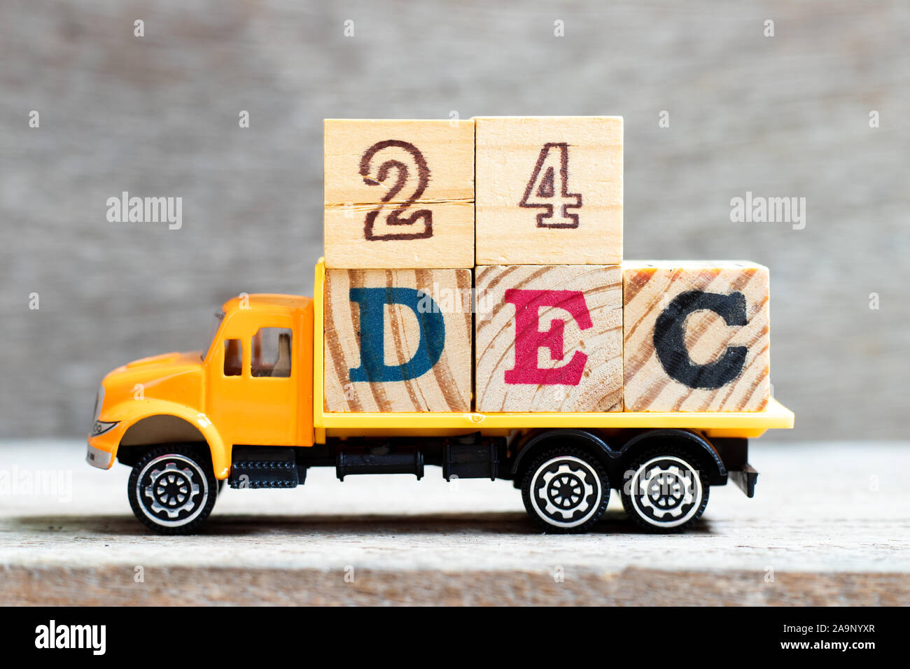 Truck hold letter block in word 24dec on wood background (Concept for ...