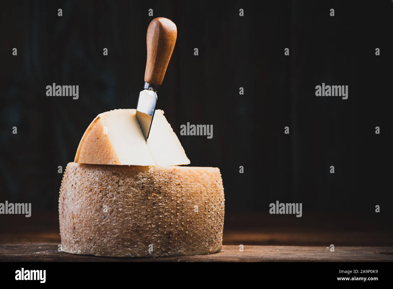 Piece Cut from Whole Matured Cheese Wheel. Traditional Food Produce ...