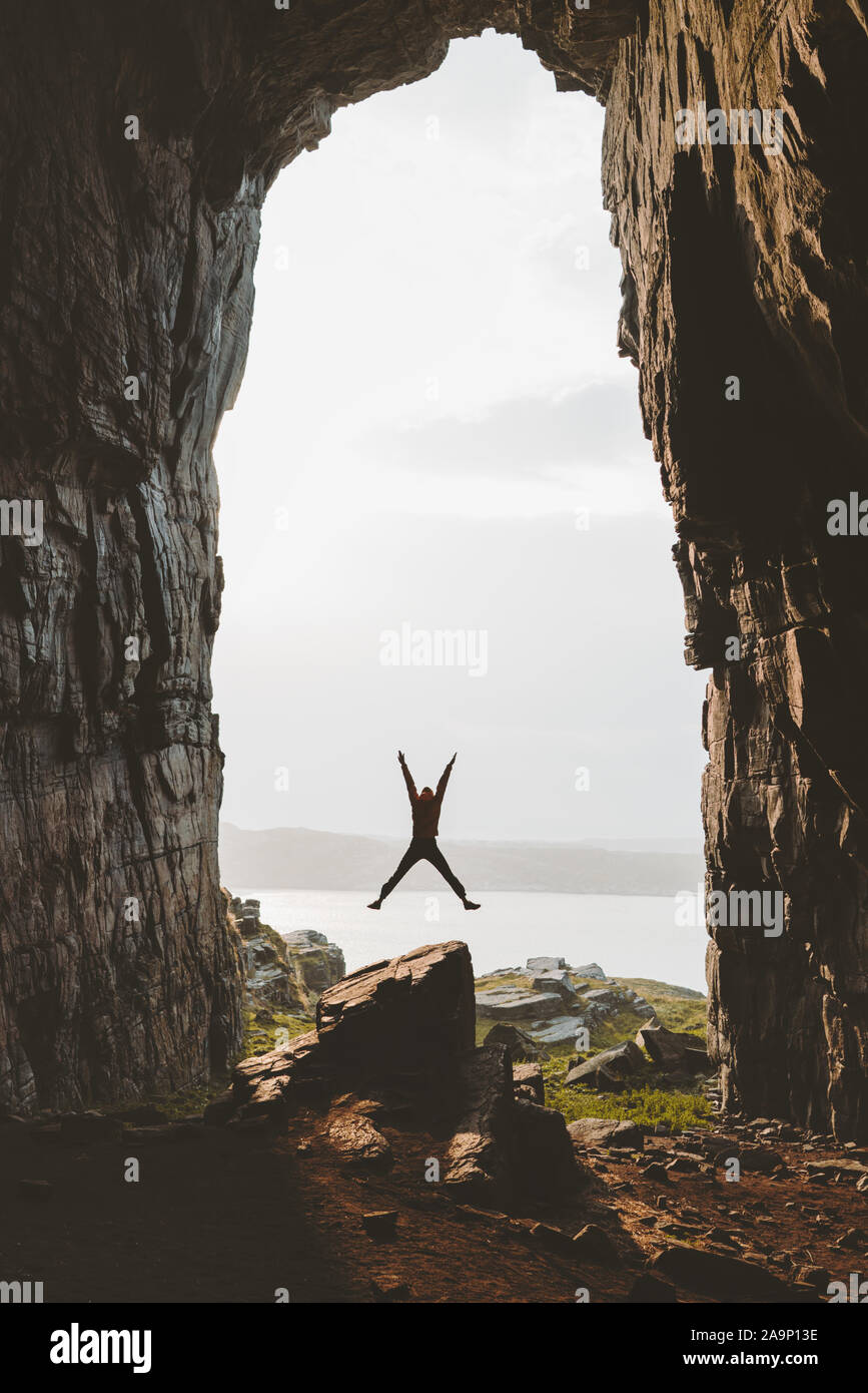 Man jumping in cave Travel adventure vacations happy emotions success ...