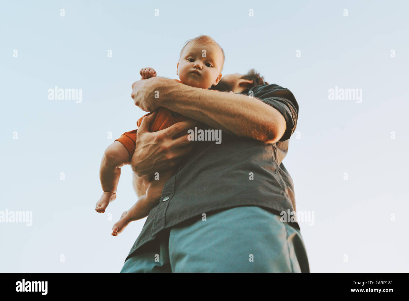 Father holding infant baby family lifestyle dad and child walking ...