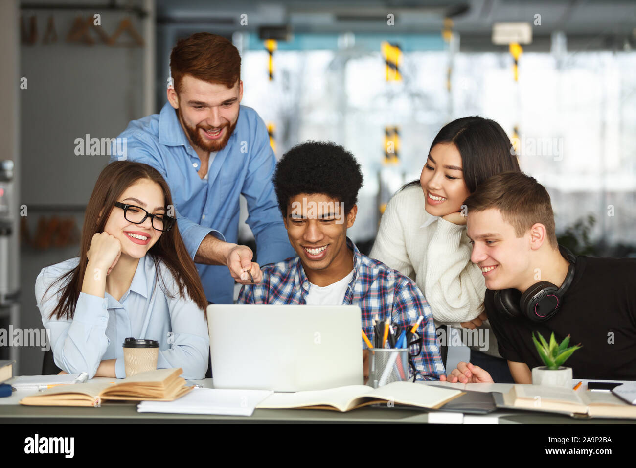 Education concept. University students using laptop in library Stock ...