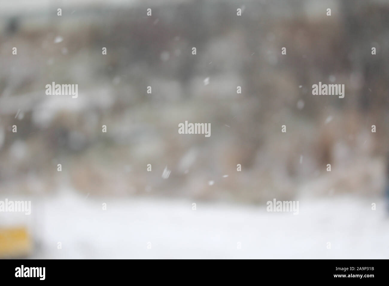 Blurred winter background with snowflakes on the foreground. White ...