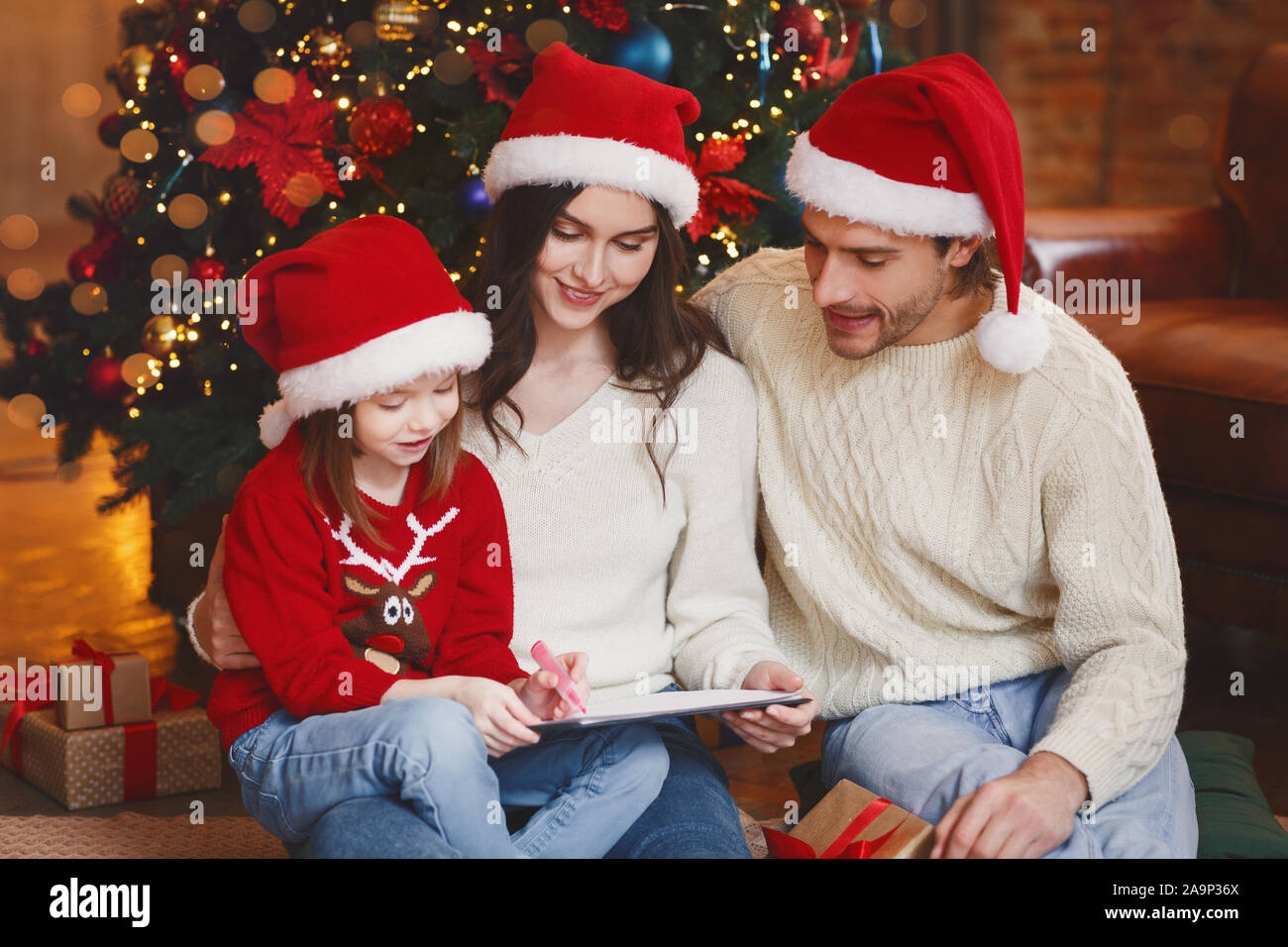 Young happy family writing letter to Santa together Stock Photo - Alamy