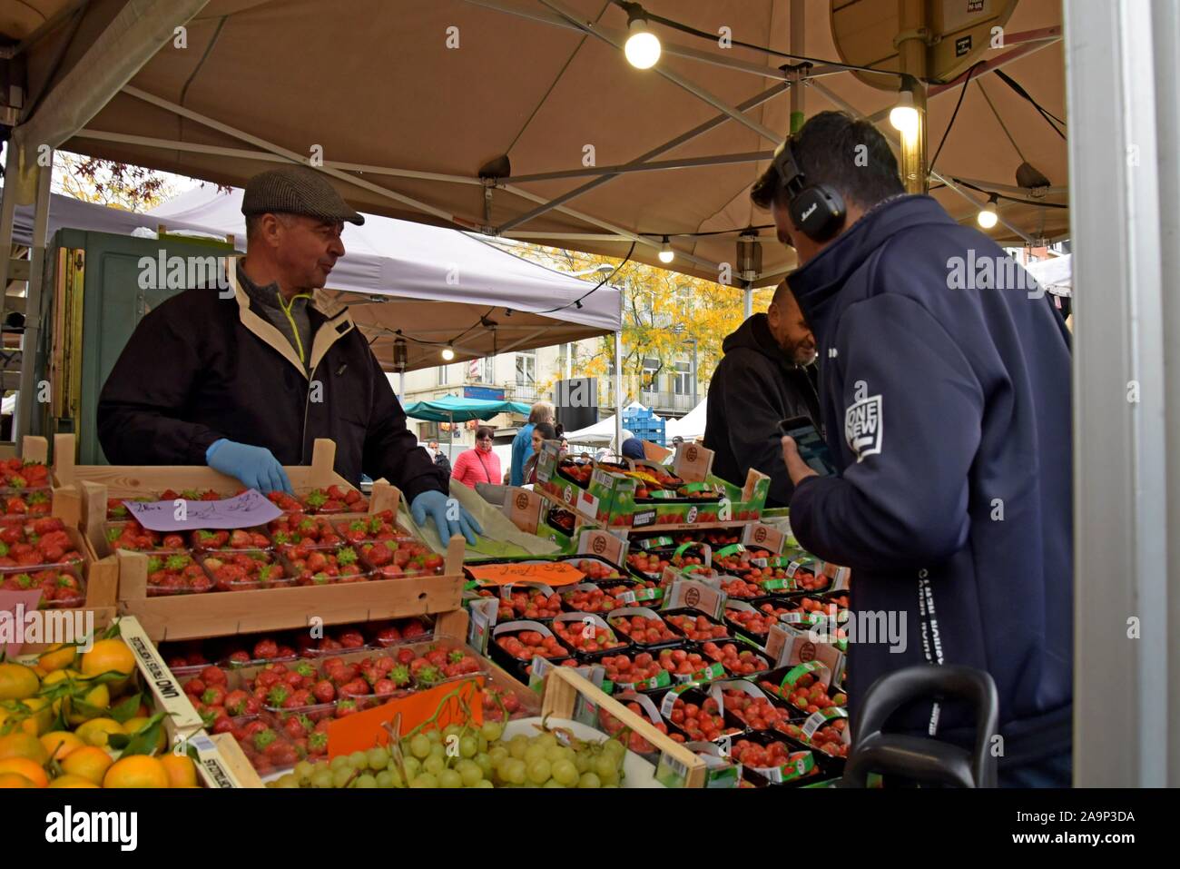 Shoppers examining and selecting fruit and vegetable produce at the ...