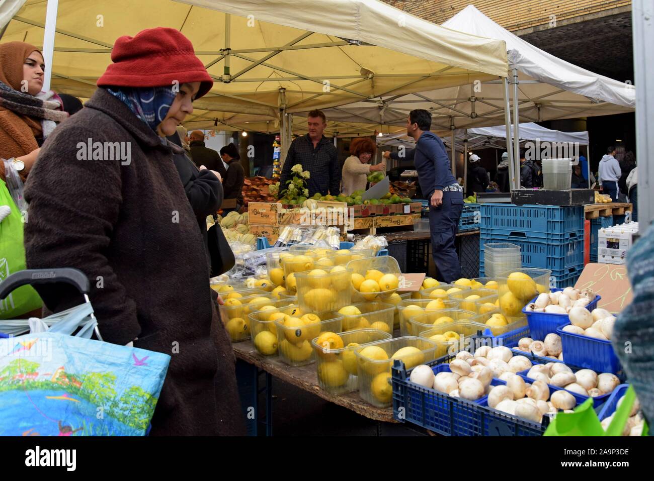 Shoppers examining and selecting fruit and vegetable produce at the ...