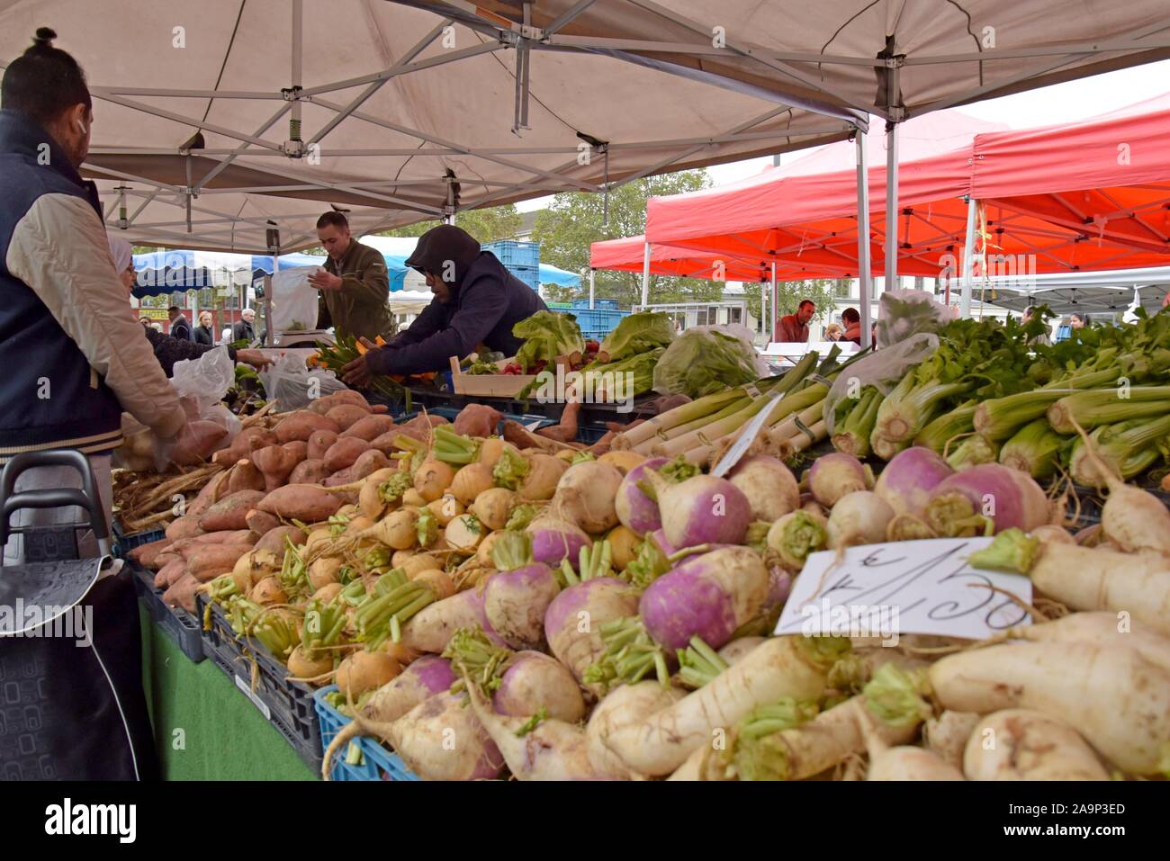 Shoppers examining and selecting fruit and vegetable produce at the ...