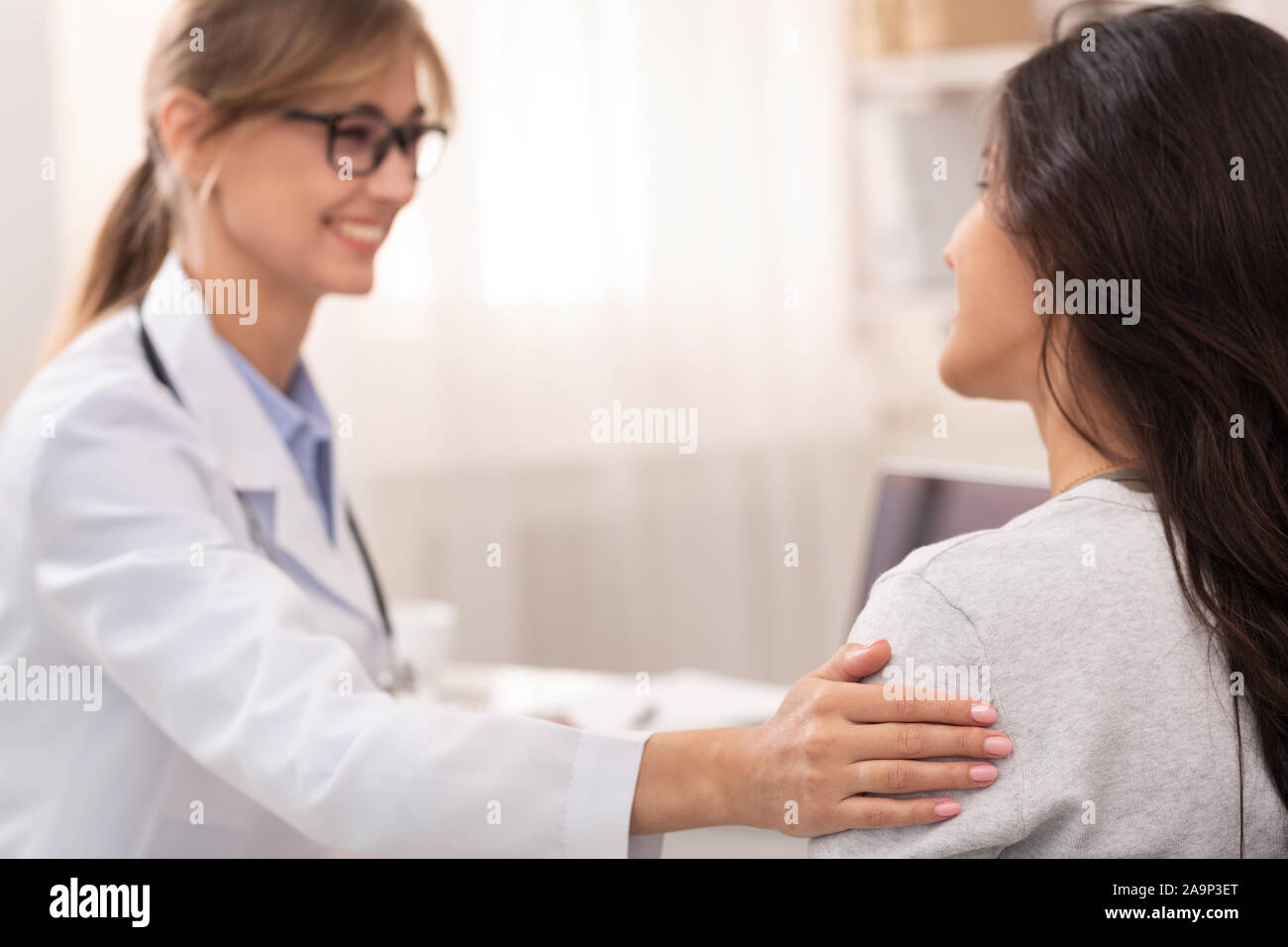 Doctor Lady Comforting Patient During Checkup In Clinic Stock Photo - Alamy