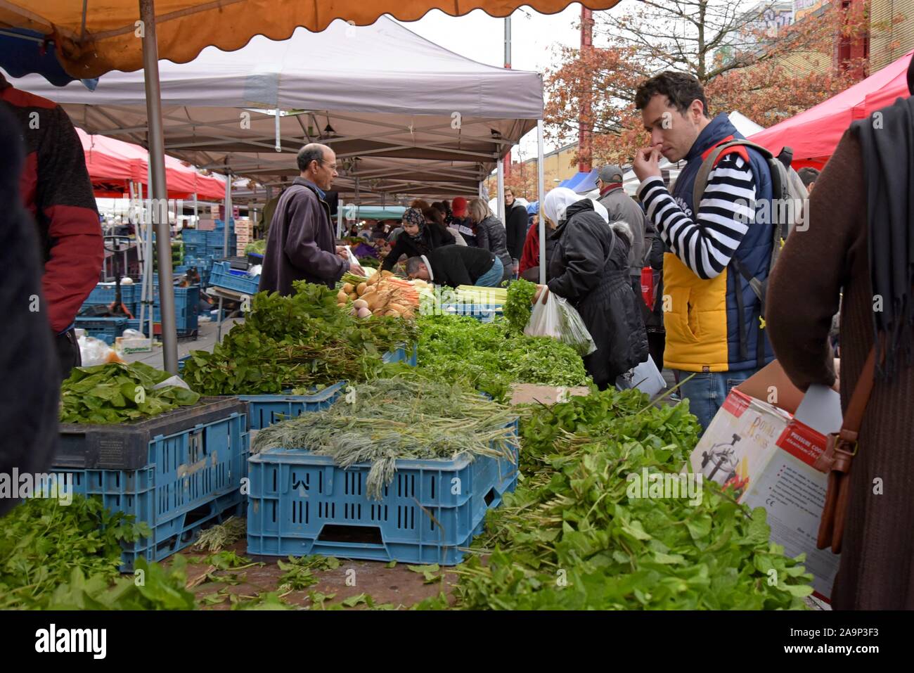 A shopper samples some coriander on a market stall at the Marche du ...