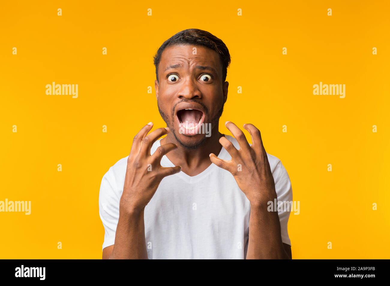 Terrified Afro Man Shouting Standing Looking At Camera, Studio Shot ...