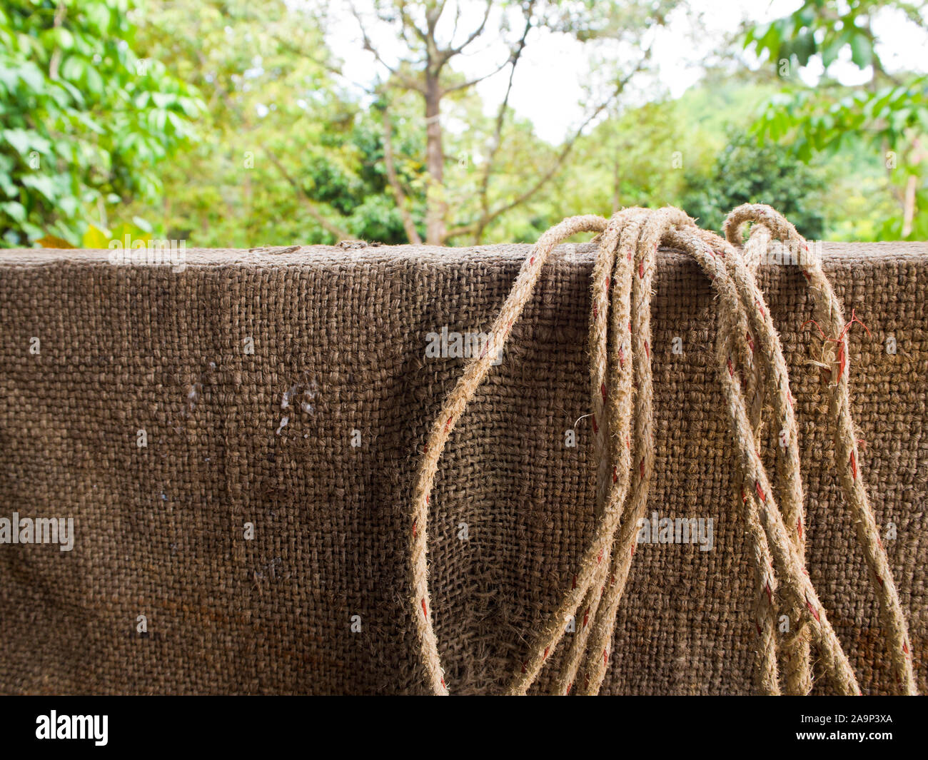 Hemp sack and rope on wall Stock Photo - Alamy