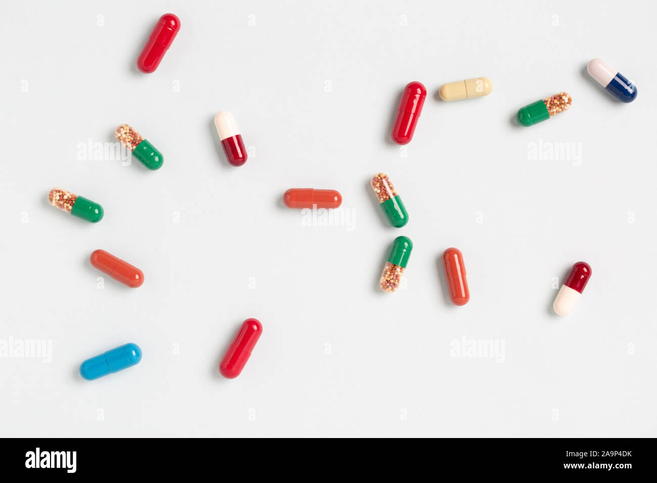Colorful medicine pills capsules on a single color background Stock ...