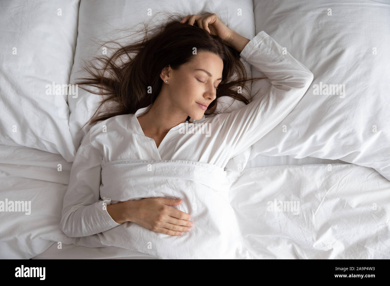 Peaceful beautiful lady relaxing sleeping in cozy bed, top view Stock ...