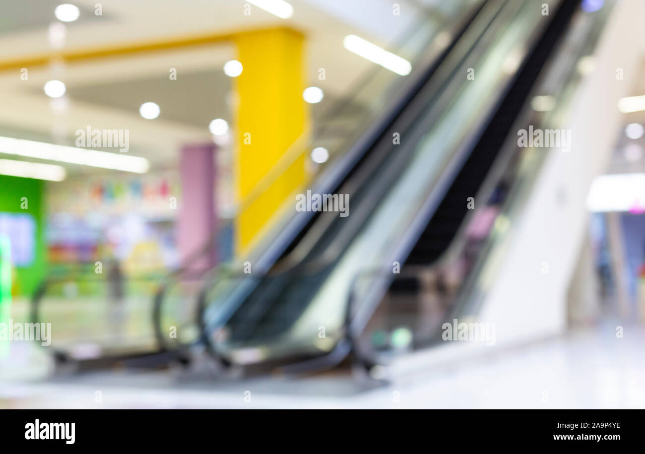 Escalator and retail stores interior in shopping mall Stock Photo - Alamy