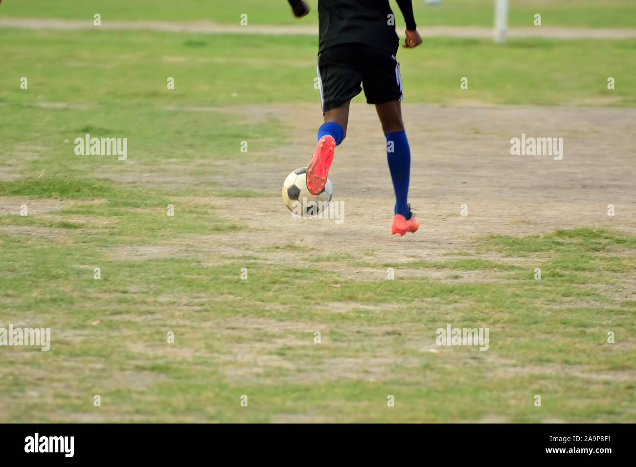 Professional sportsperson practicing football grass hi-res stock ...