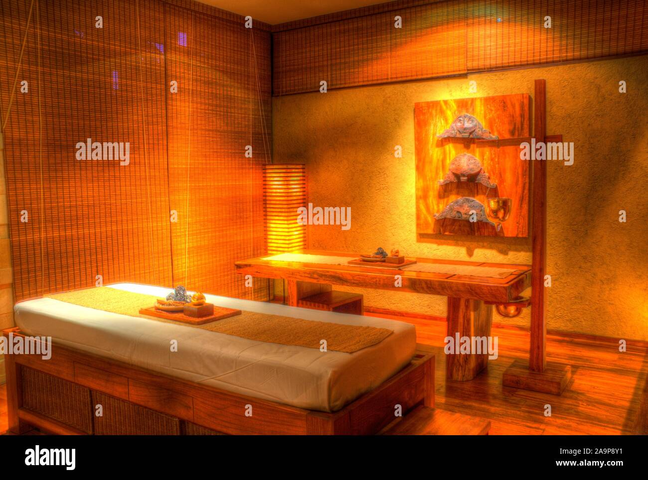 spa massage therapy room with massage therapy table and massage oil ...