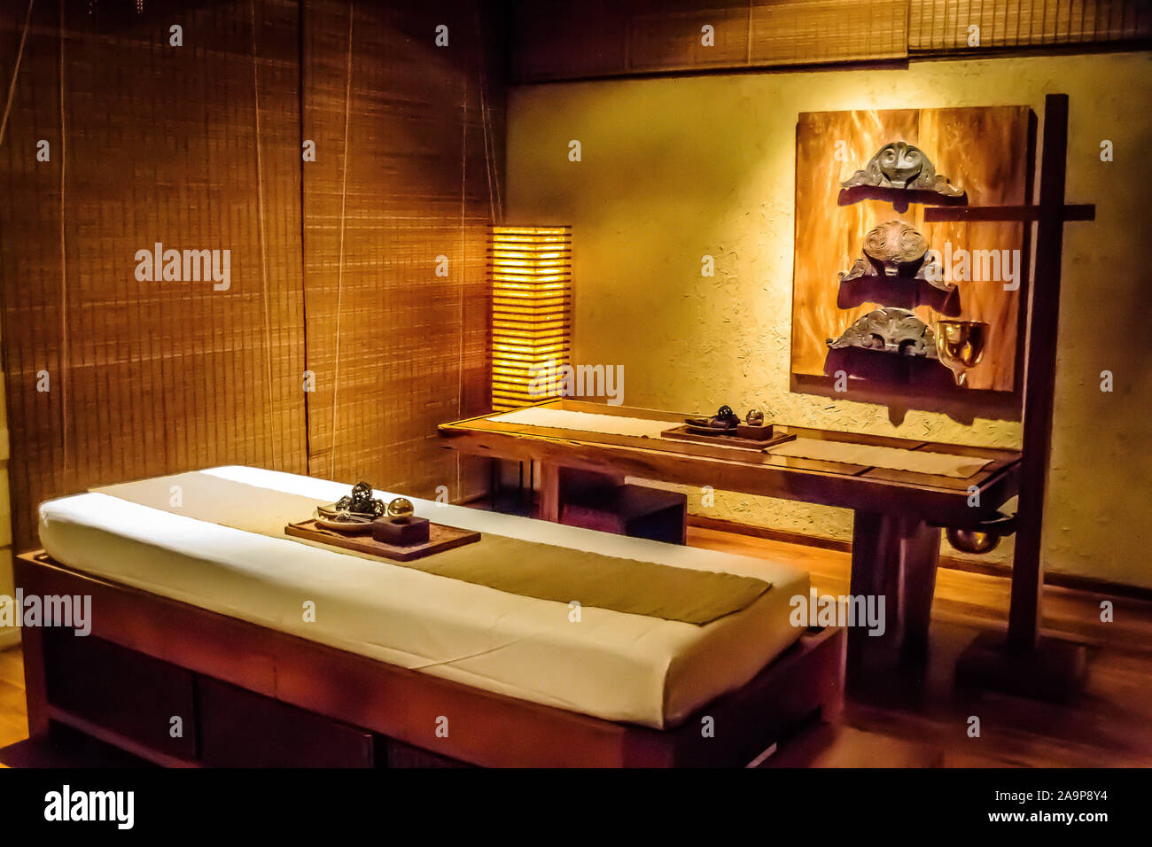 spa massage therapy room with massage therapy table and massage oil ...