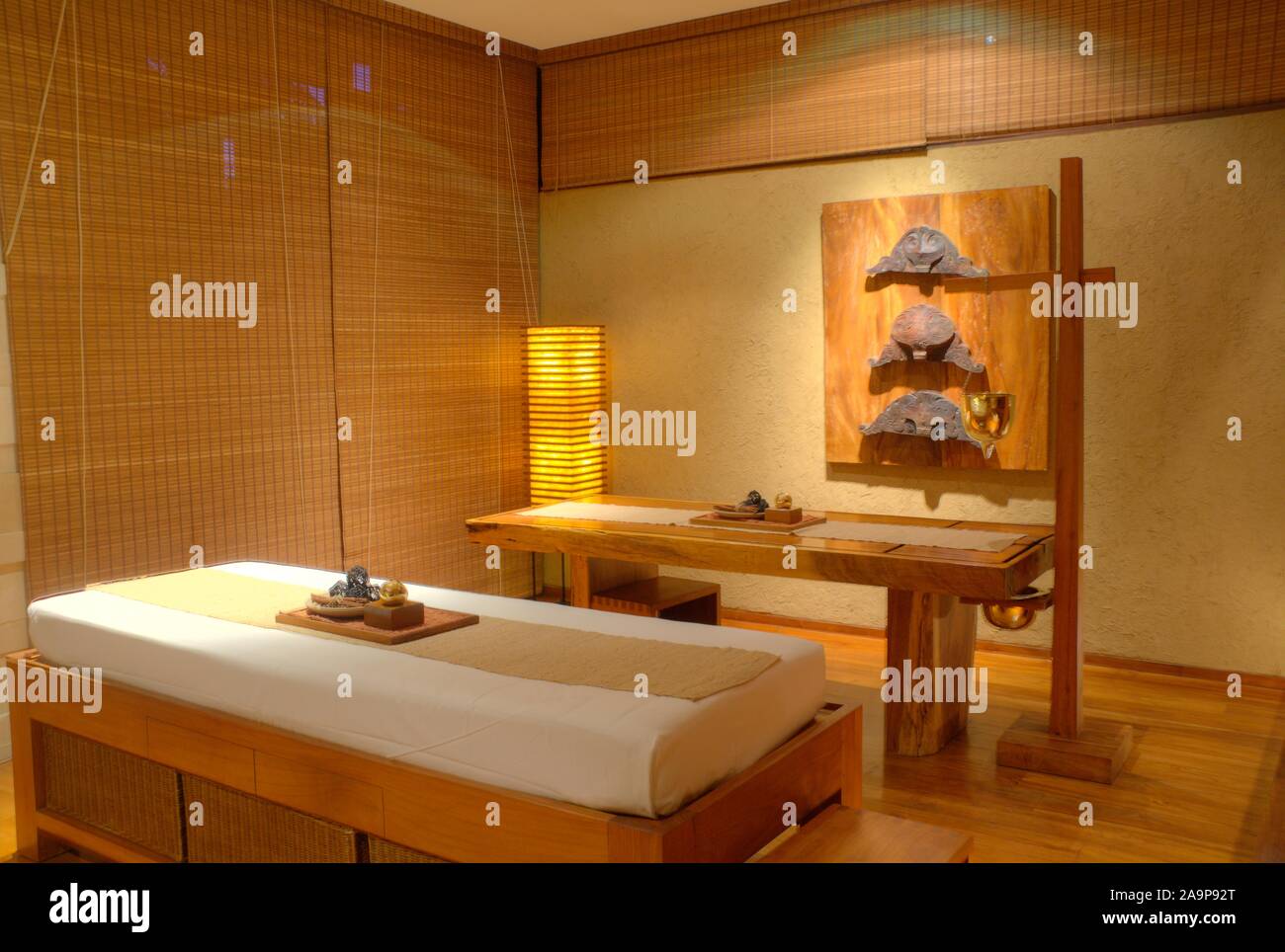 spa massage therapy room with massage therapy table and massage oil ...