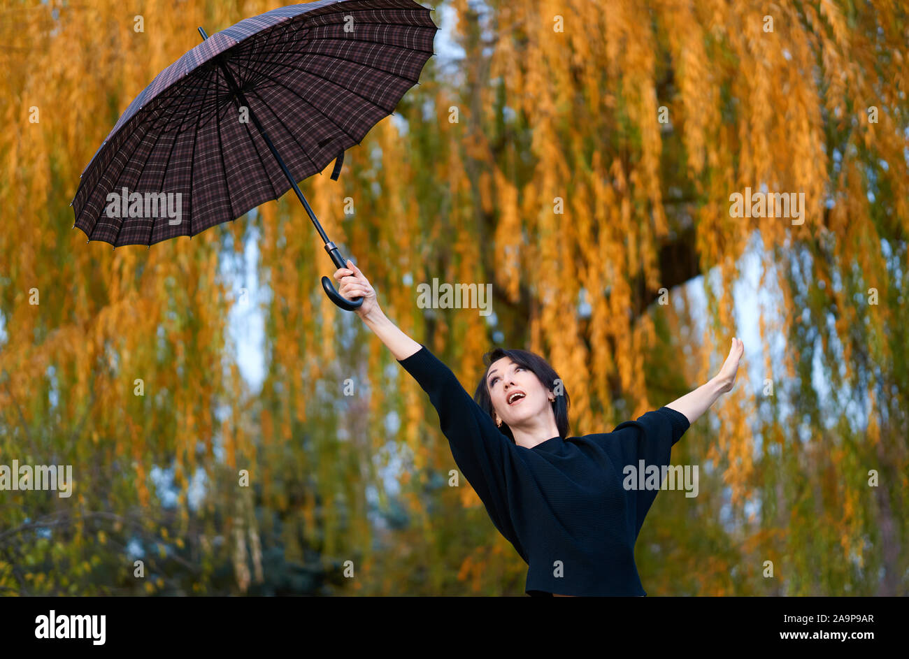 Woman opening umbrella hi-res stock photography and images - Alamy