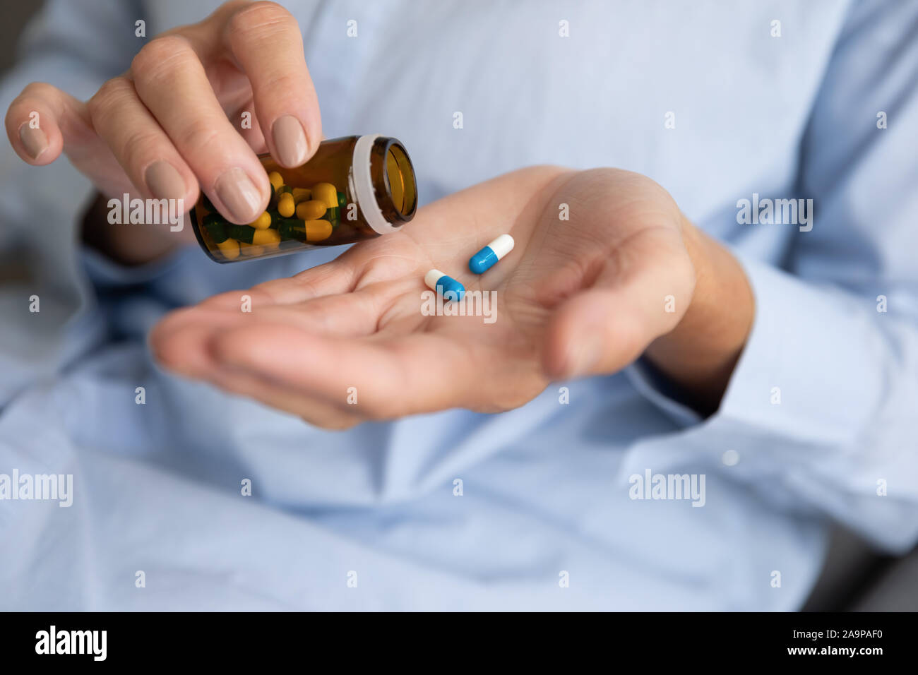 Elderly woman pouring pills from bottle on hand, closeup view Stock ...