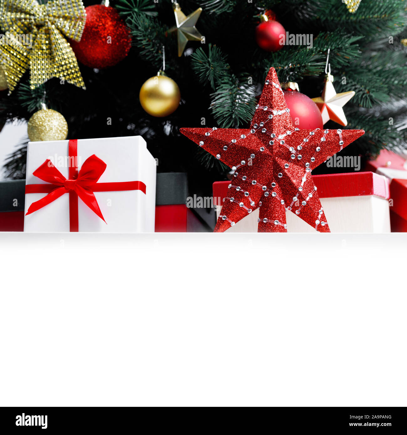 Decorated Christmas gifts and star under tree with baubles isolated on ...