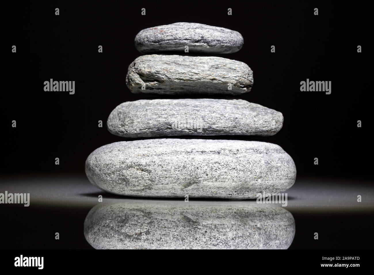 four stacked stones isolated Stock Photo - Alamy