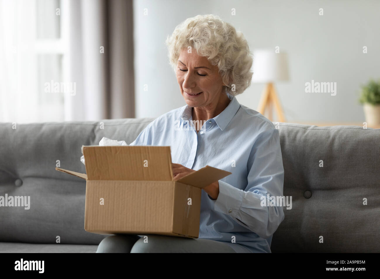 Mature woman opening package hi-res stock photography and images - Alamy