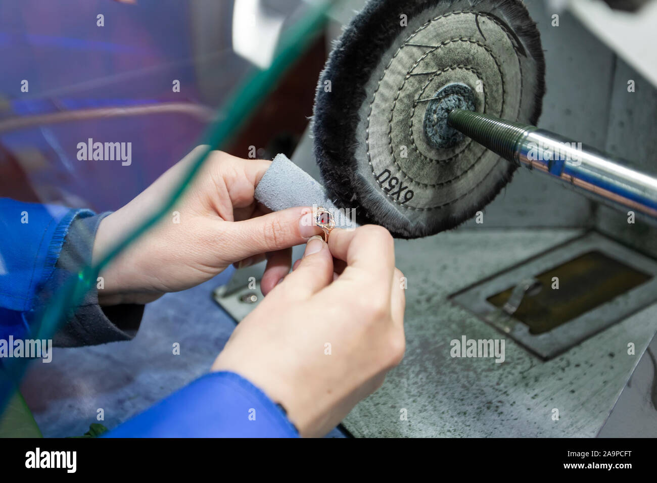 Jewelry industry. Hands make a golden decoration. Grinds the ring Stock ...