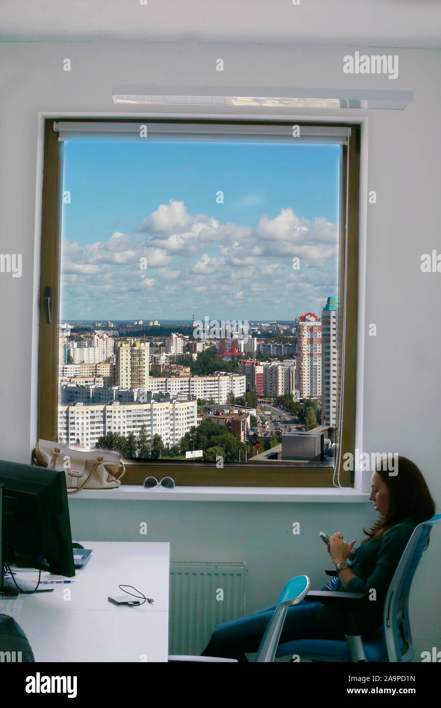 Silhouette of a woman in the office at work against the background of a ...