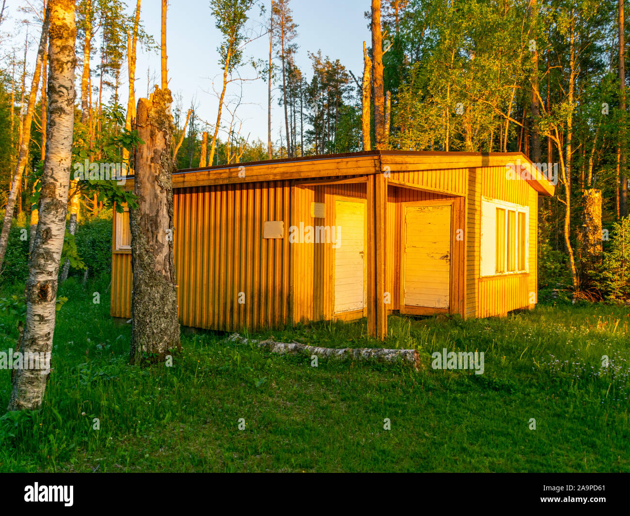 landscape with wooden house forest sunset light Stock Photo - Alamy