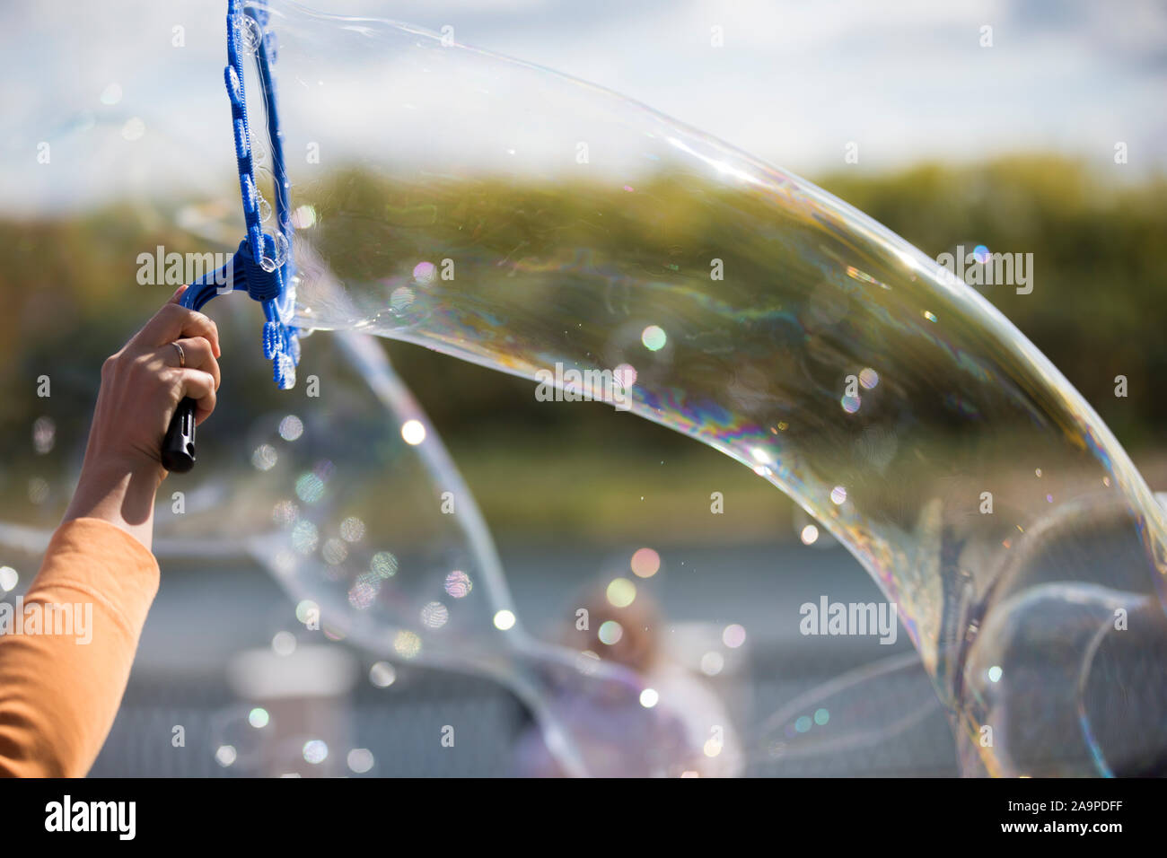 Hand blows soap bubbles Stock Photo - Alamy