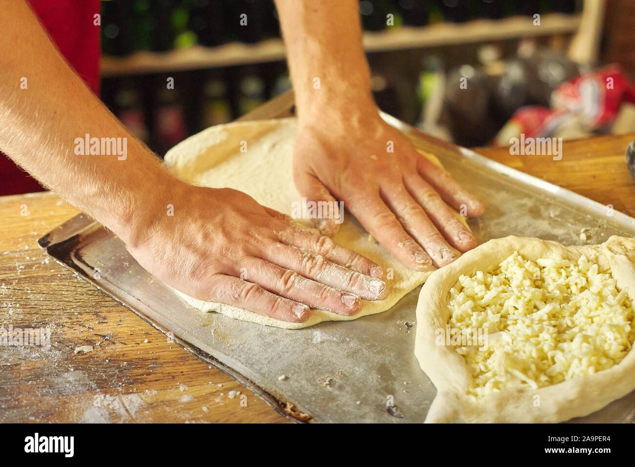 Close-up hands of male baker preparing traditional Georgian cuisine ...