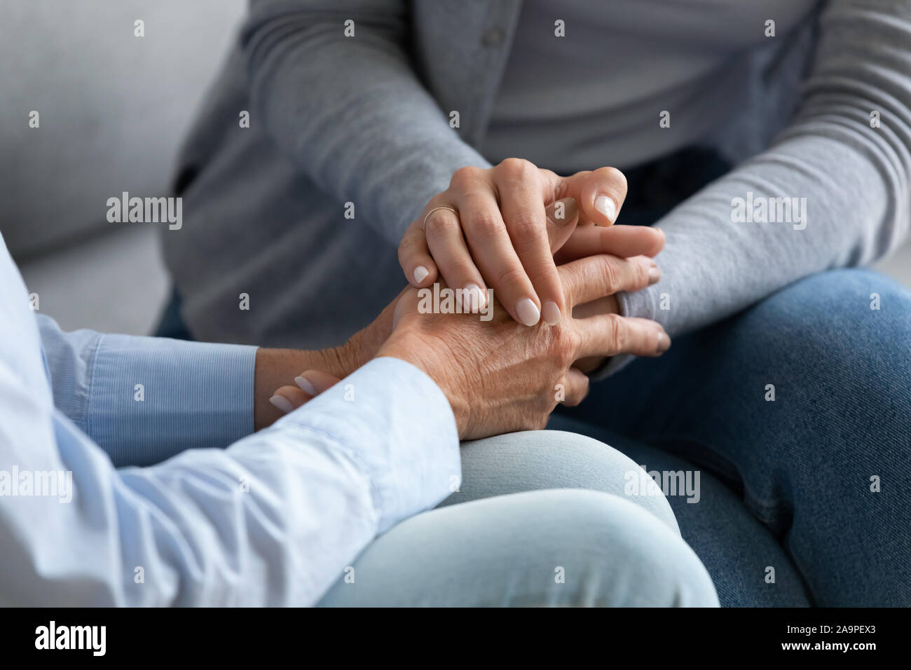 Young woman granddaughter hold old female grandma hand, closeup Stock ...