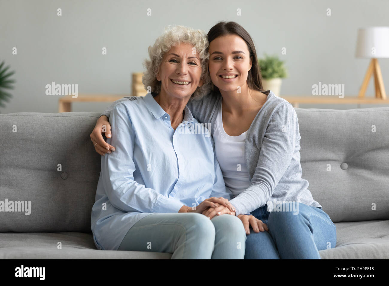 Happy affectionate two generation women grandmother and granddaughter ...