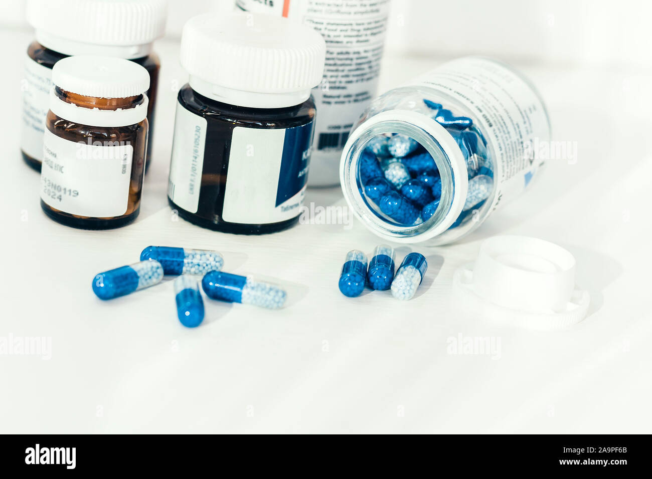 Medicine pills or capsules and bottles on white background with copy ...
