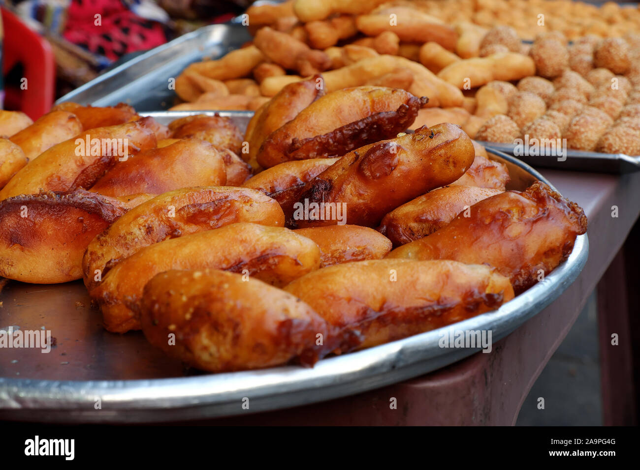 Vietnamese outdoor food street at Ho Chi Minh city in evening, tray of ...