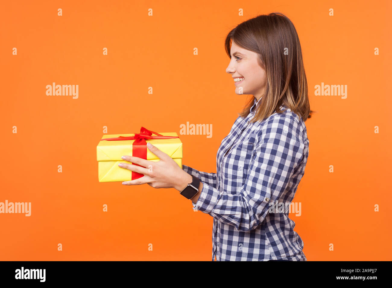 Side view portrait of generous friendly woman with brown hair in casual ...