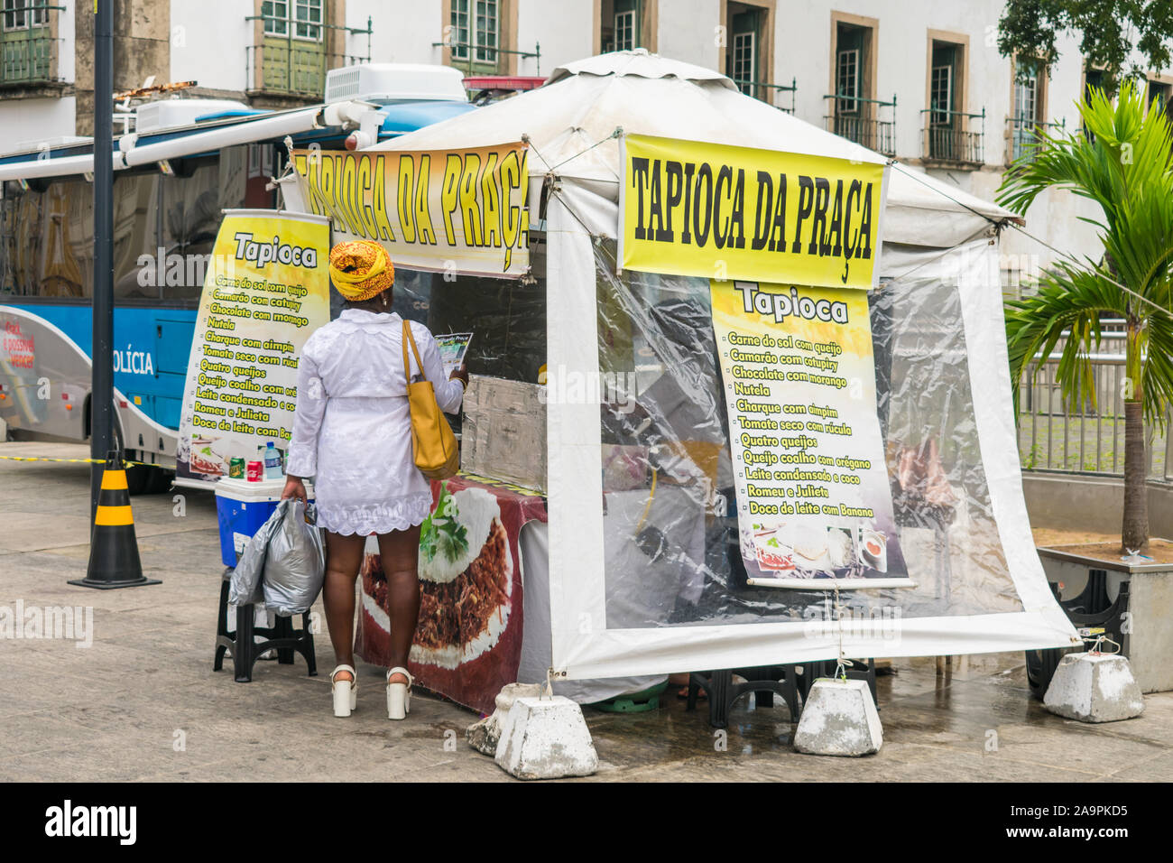 Afro Brazilian woman with a turban buying tapioca (popular snack) from ...