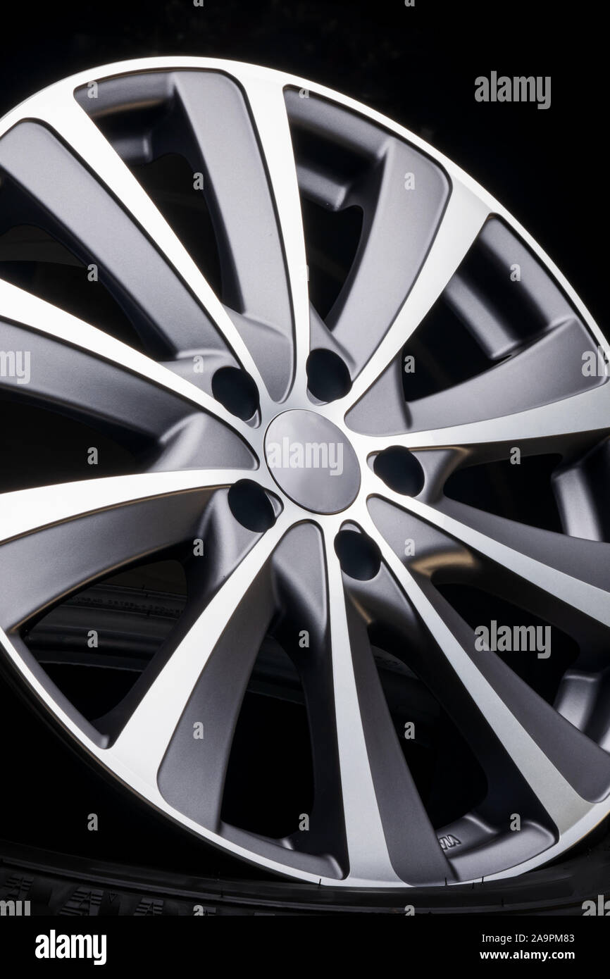 car alloy wheel close up, beautiful design of smooth curved spokes ...