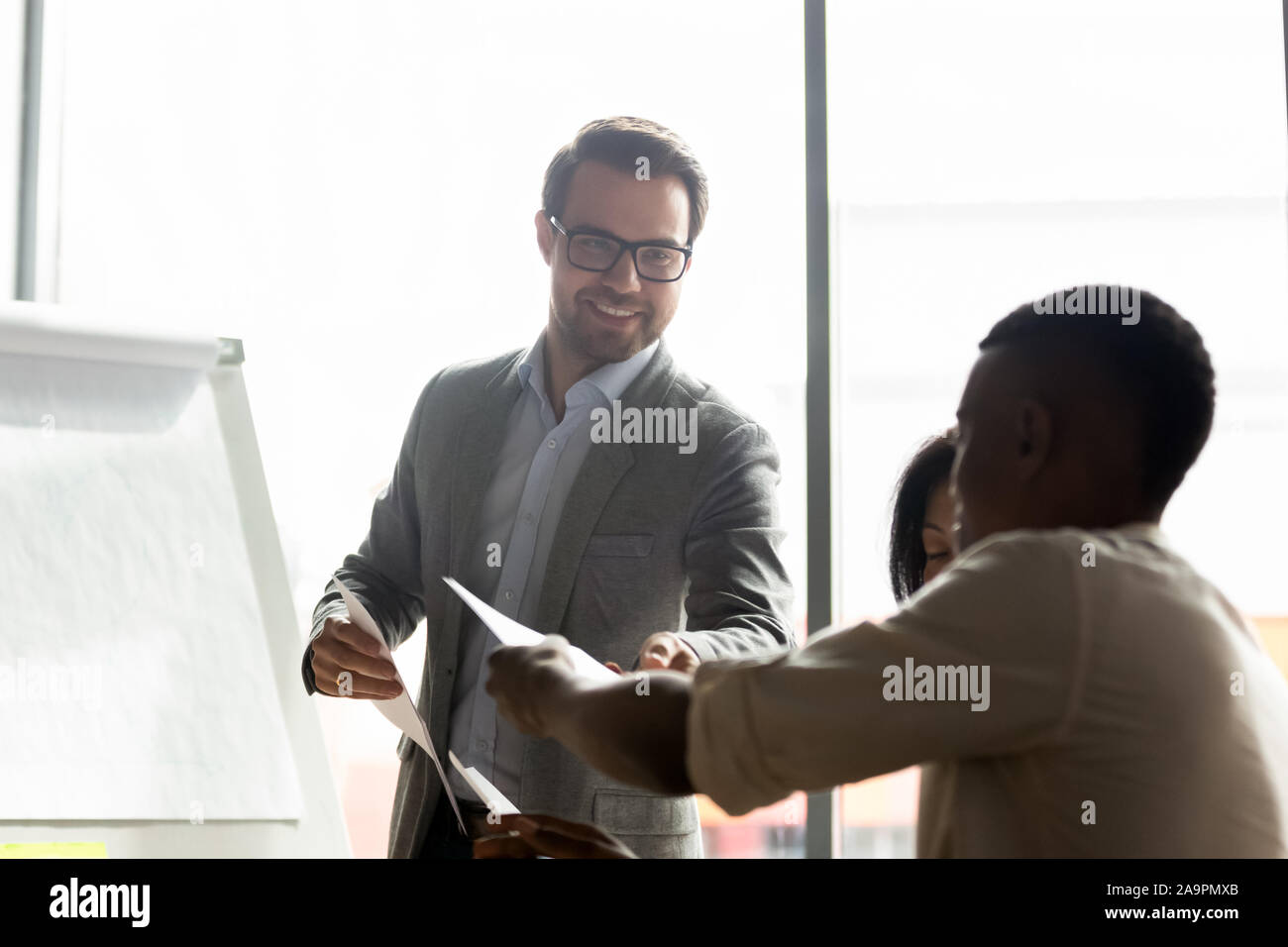 Smiling african american employee giving paper report to coach Stock ...