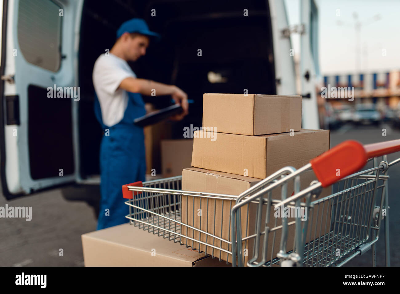 Parcel boxes in cargo cart, delivery service Stock Photo - Alamy
