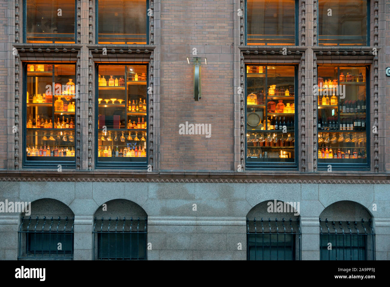Drinks bottles in window of 'The Alchemist' Bar Stock Photo - Alamy