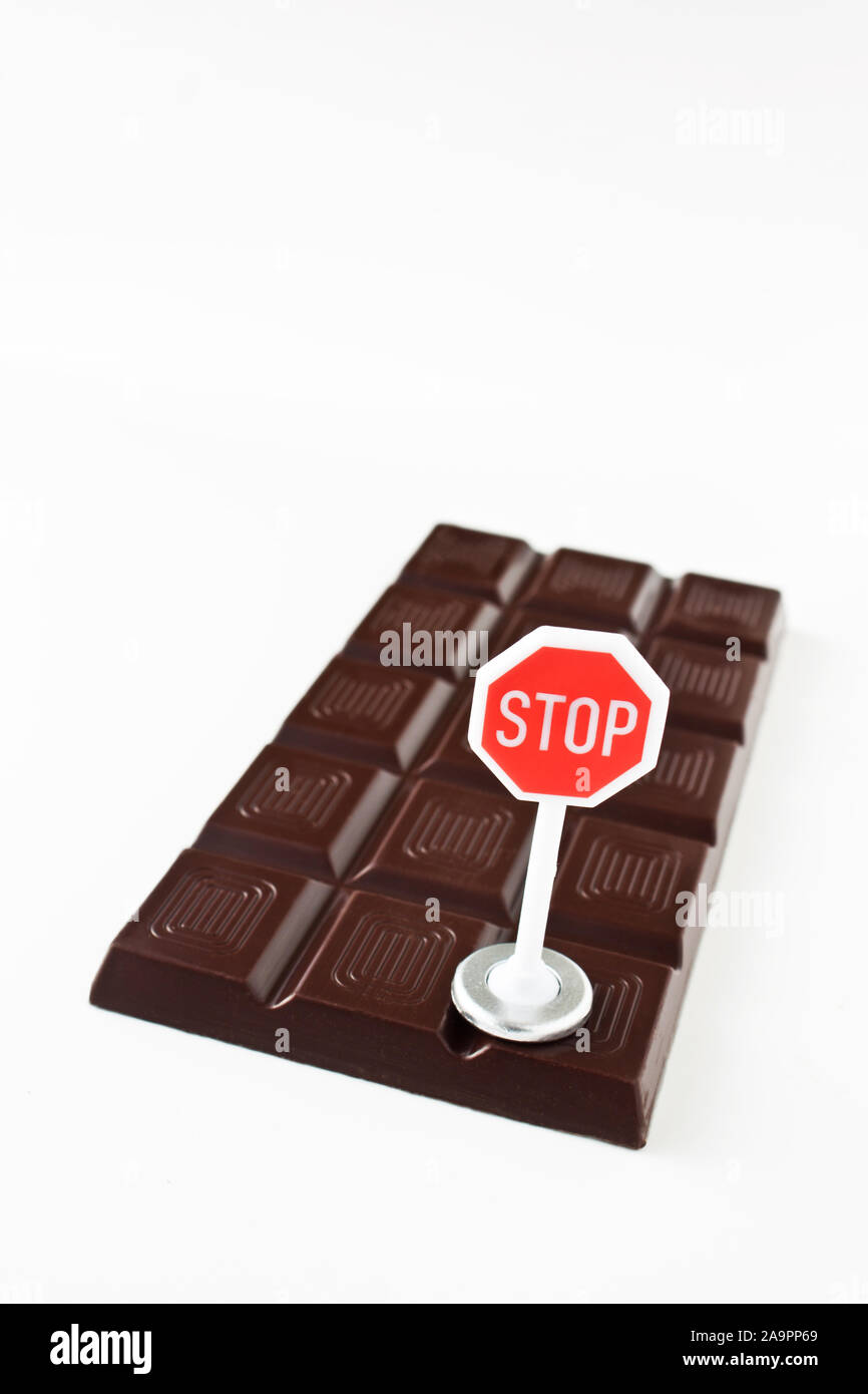 Chocolate and stop sign on white background close-up Stock Photo - Alamy