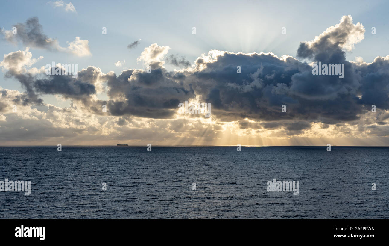 sunset on the sea with beautiful cloud patterns, sun rays, ship Stock ...